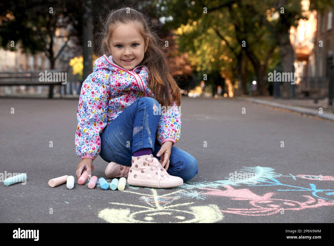 Child drawing family with chalk on asphalt Stock Photo - Alamy