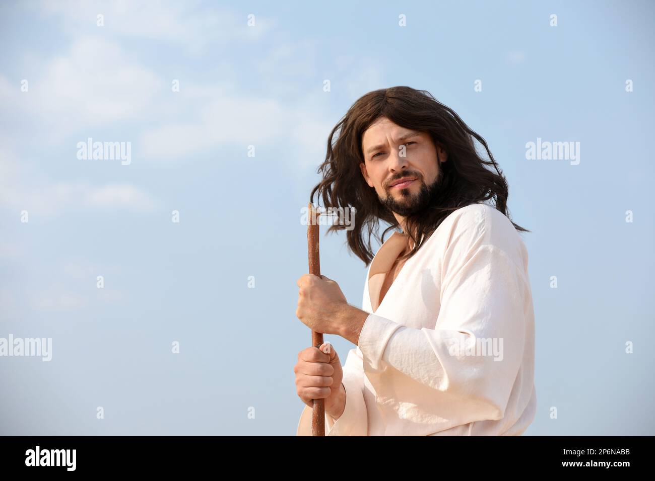 Jesus Christ with stick against blue sky Stock Photo - Alamy Jesus Christ with stick against blue sky Stock Photo - Alamy