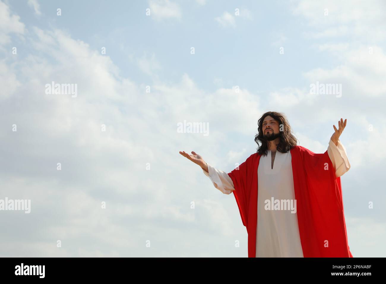Jesus Christ raising hands against blue sky. Space for text Stock Photo ...