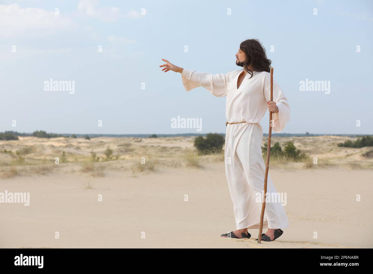 Jesus Christ walking with stick in desert. Space for text Stock Photo ...
