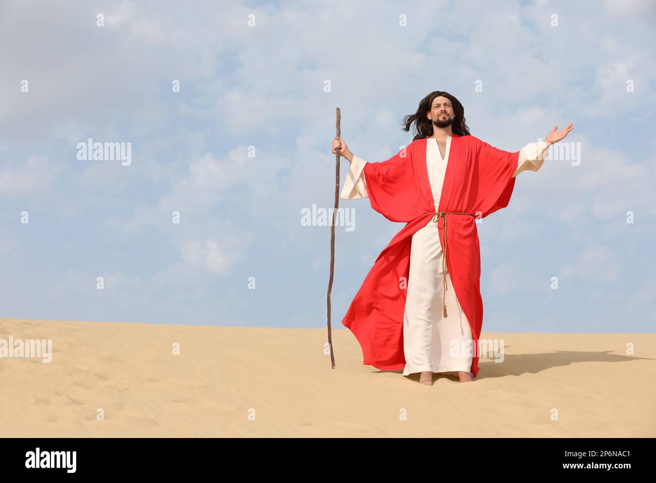 Jesus Christ walking with stick in desert. Space for text Stock Photo ...