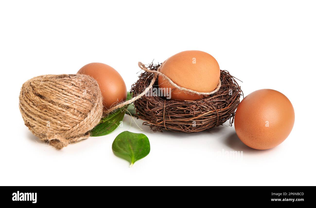 Nest with Easter eggs and rope on white background Stock Photo - Alamy