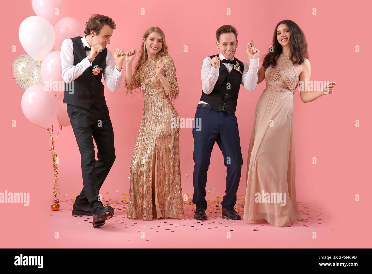 Beautiful couples dressed for prom dancing on pink background Stock ...