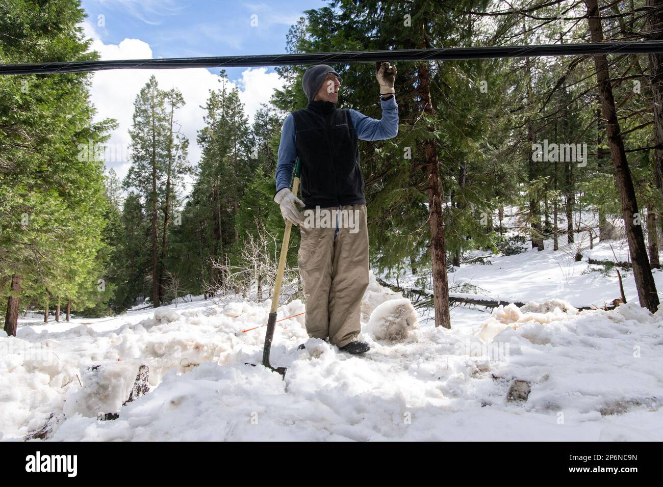 Magra, CA, USA. 7th Mar, 2023. Bob Cammer touches a damaged phone line ...