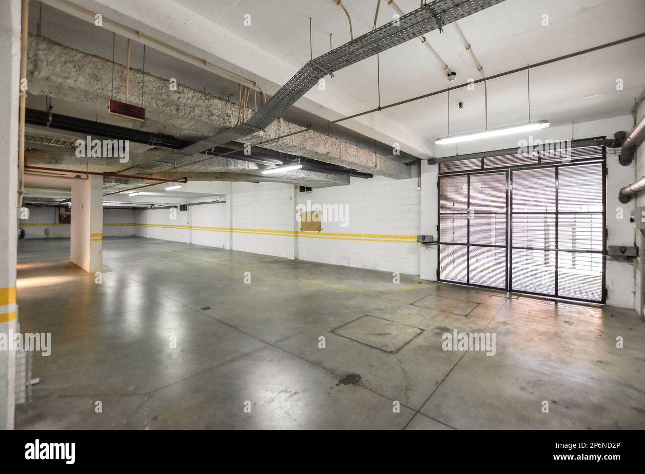 the inside of an empty parking garage with yellow lines on the floor ...