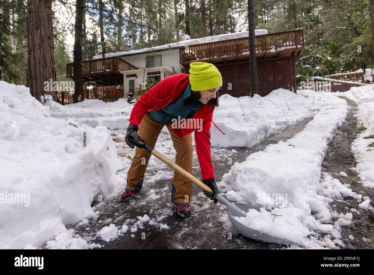 Magra, CA, USA. 7th Mar, 2023. Alexis Berry clears the driveway to her ...