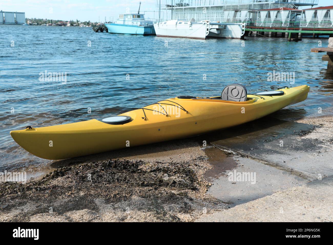Modern kayak on beach near river. Summer camp activity Stock Photo - Alamy
