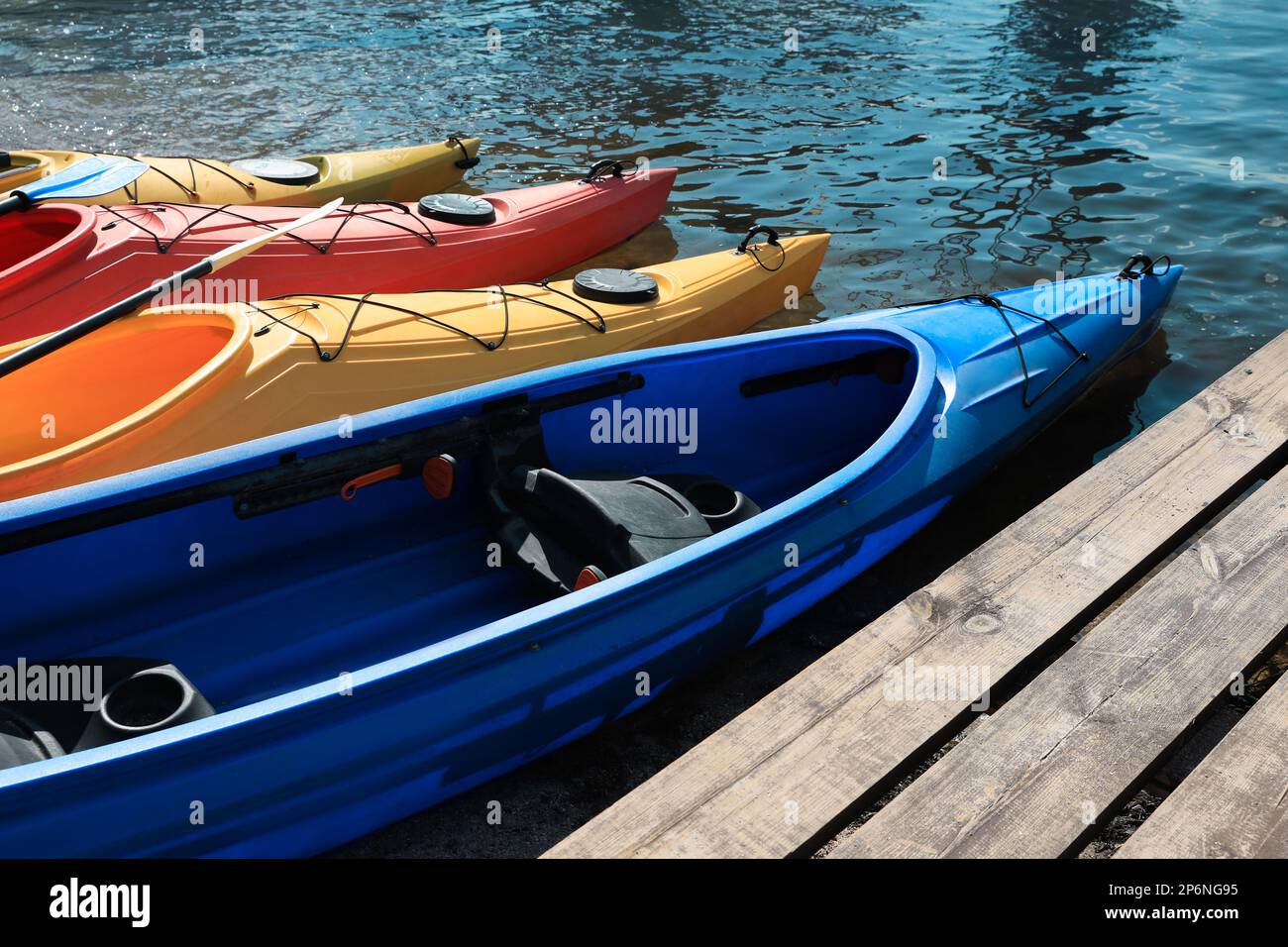 Modern kayaks with paddles on river. Summer camp activity Stock Photo ...