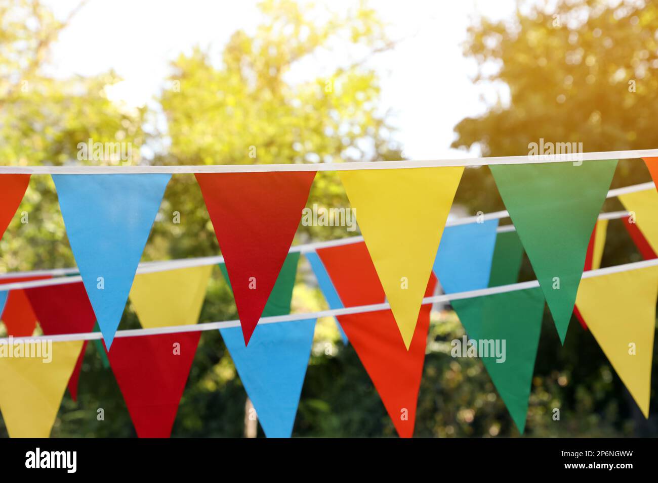 Colorful bunting flags in park. Party decor Stock Photo - Alamy