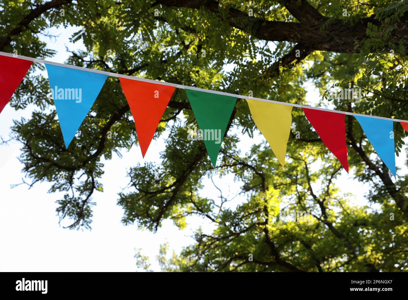 Colorful bunting flags in park. Party decor Stock Photo - Alamy