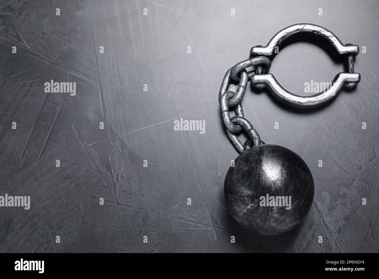 Prisoner ball with chain on grey table, top view. Space for text Stock ...