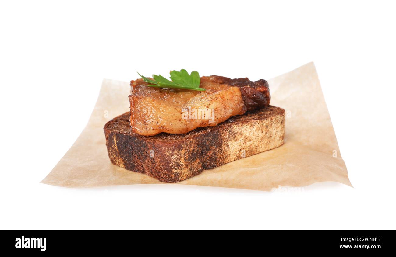 Rye bread with tasty fried crackling and parsley on white background ...