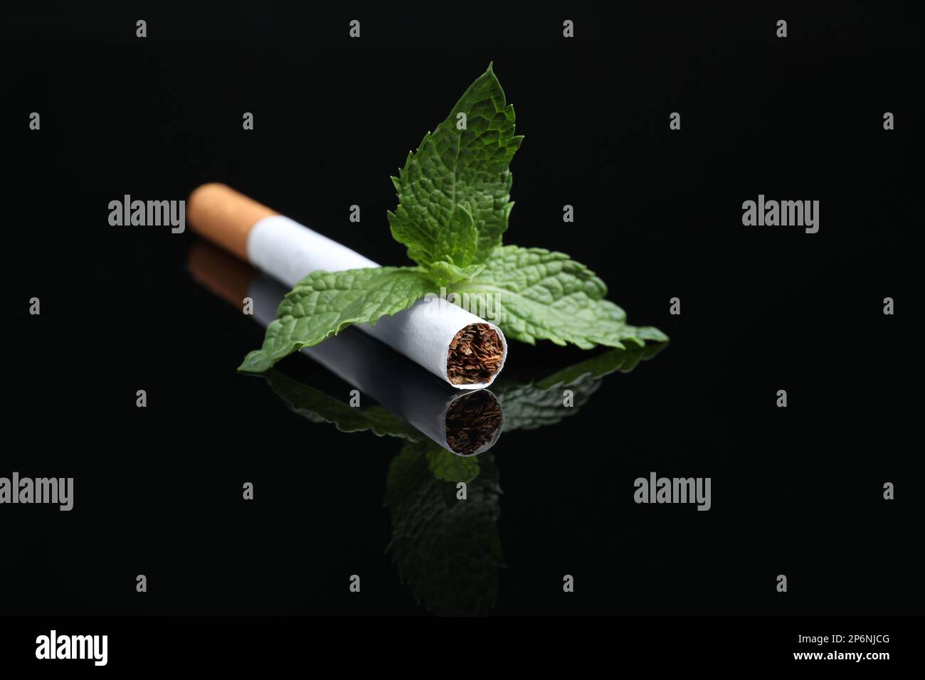 Menthol cigarette and mint on black background Stock Photo - Alamy