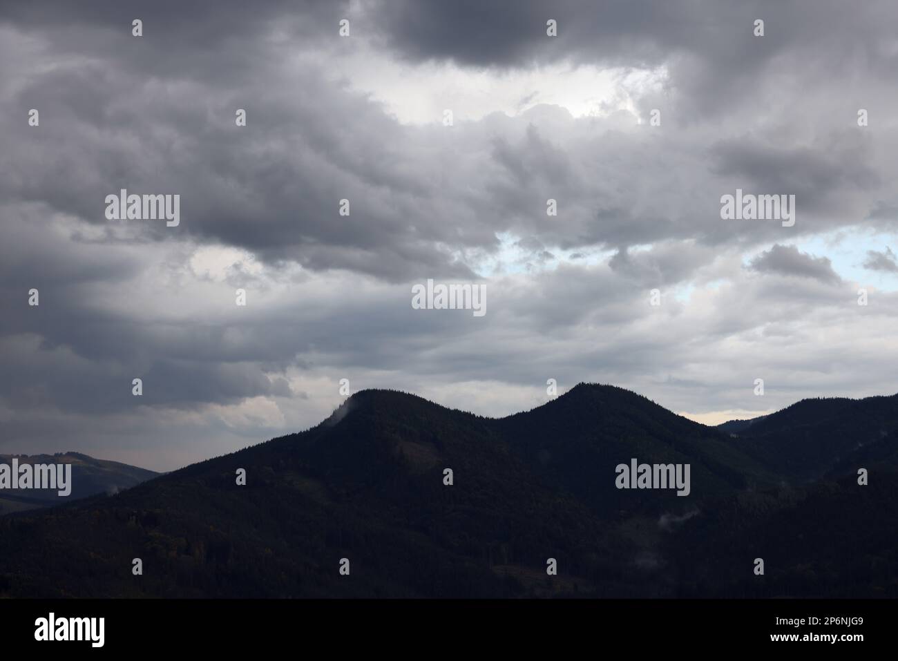 View of sky with grey thunder clouds over mountains Stock Photo - Alamy