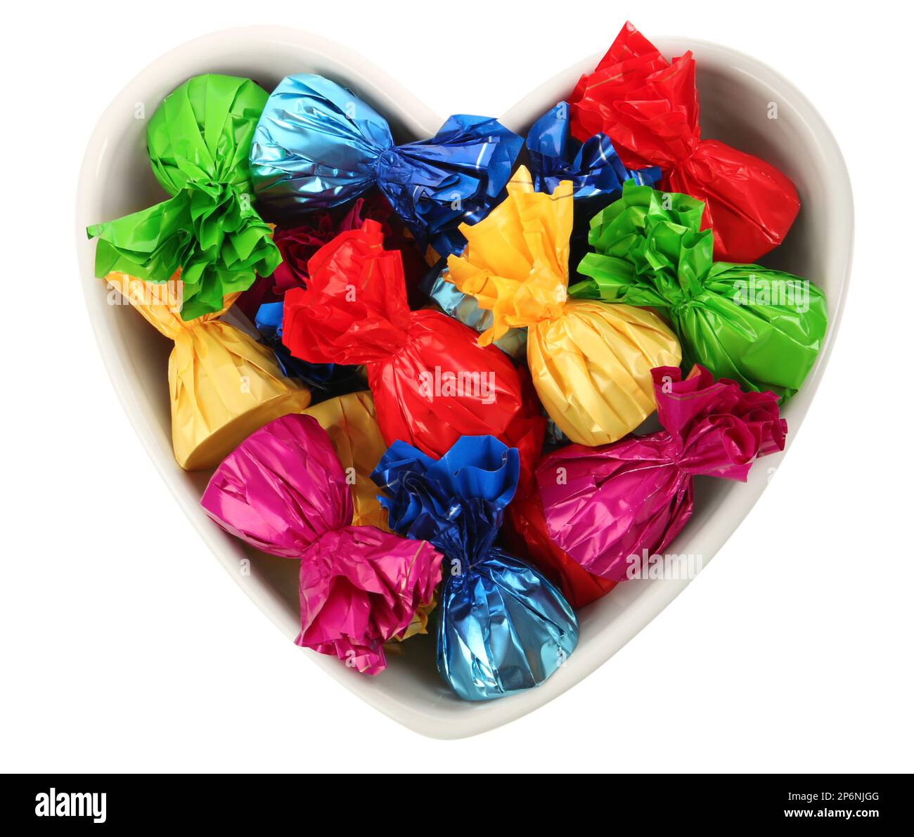 Heart shaped plate with candies in colorful wrappers isolated on white ...