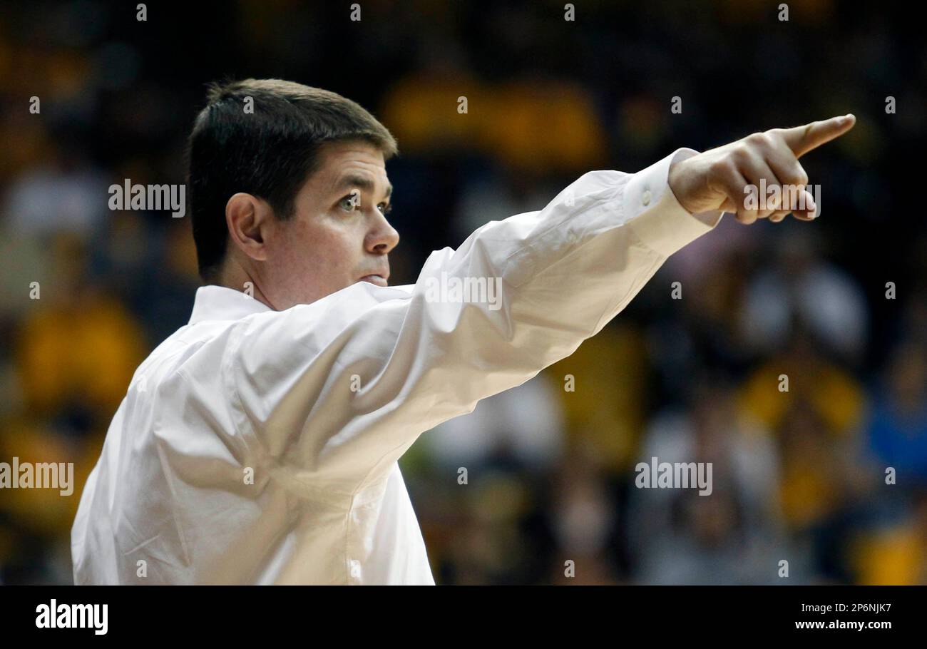 UNLV head coach Dave Rice points toward the scoreboard during an NCAA ...