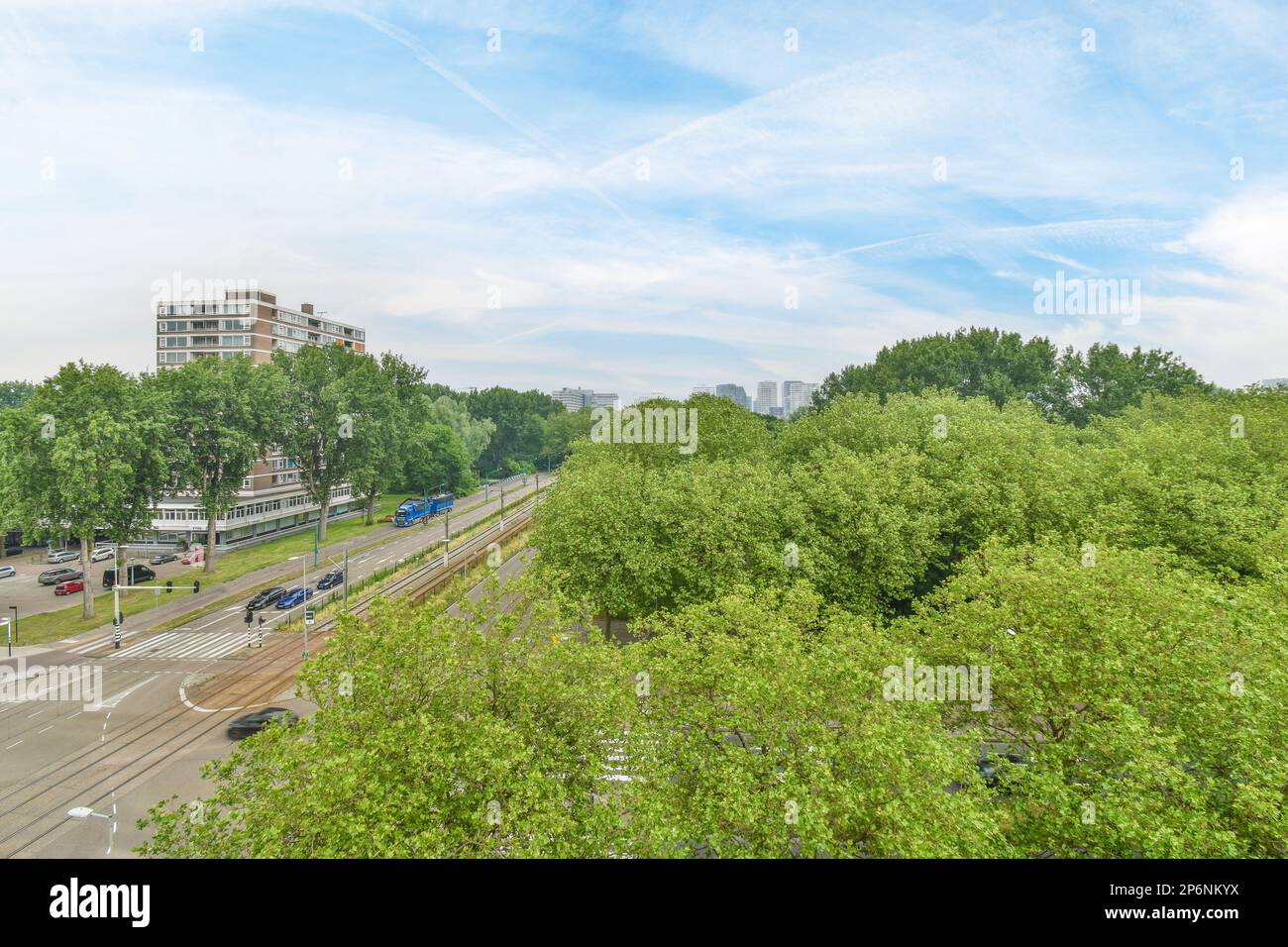 a city street with trees and buildings in the background, taken from a ...