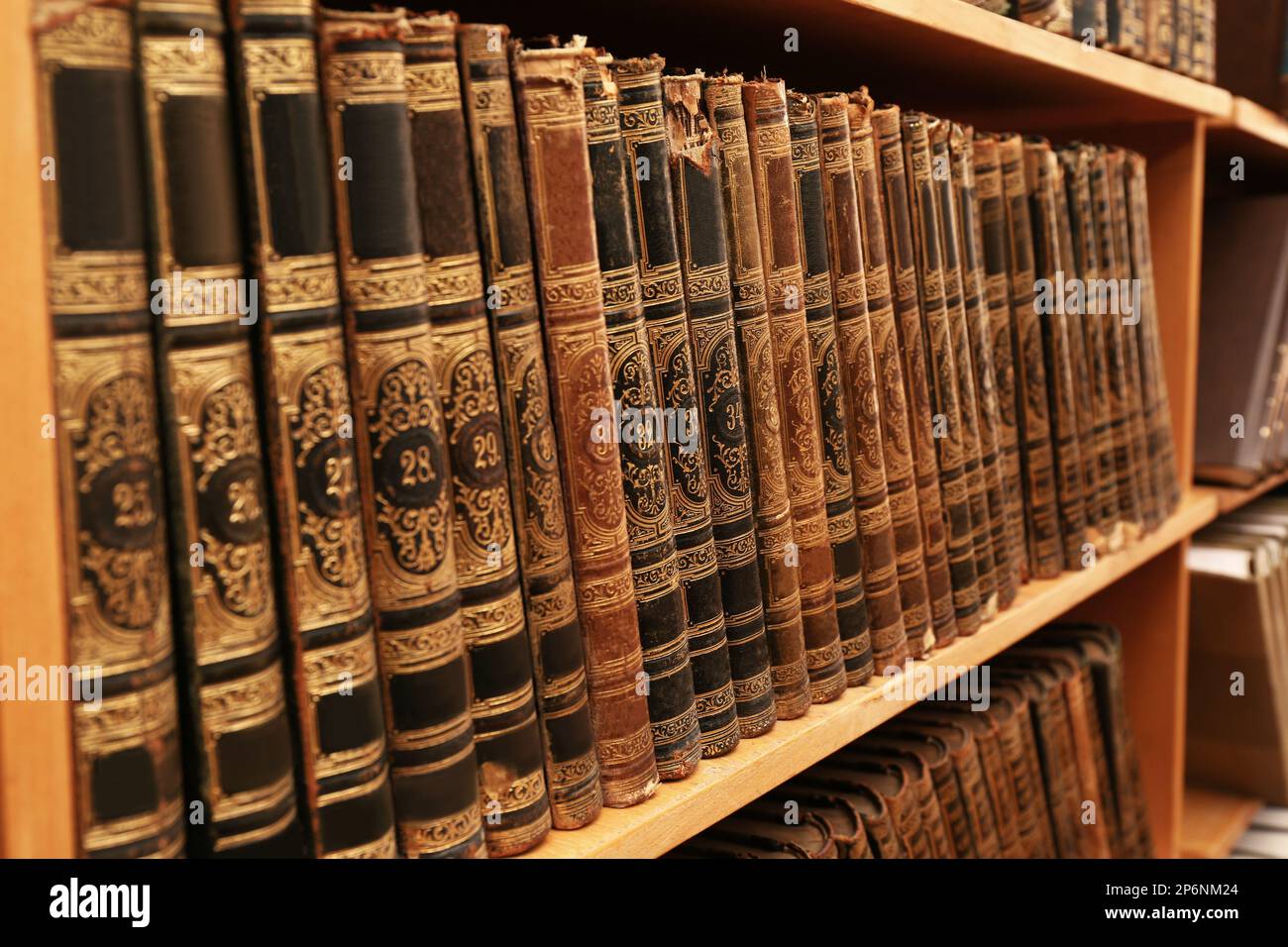 Collection of old books on shelf in library Stock Photo - Alamy