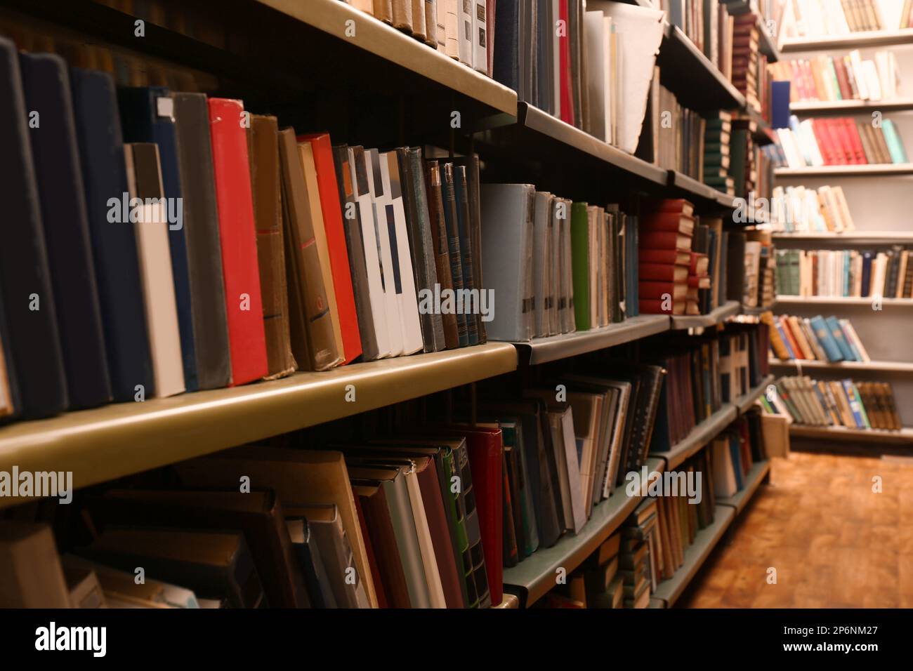 Collection of different books on shelves in library Stock Photo - Alamy