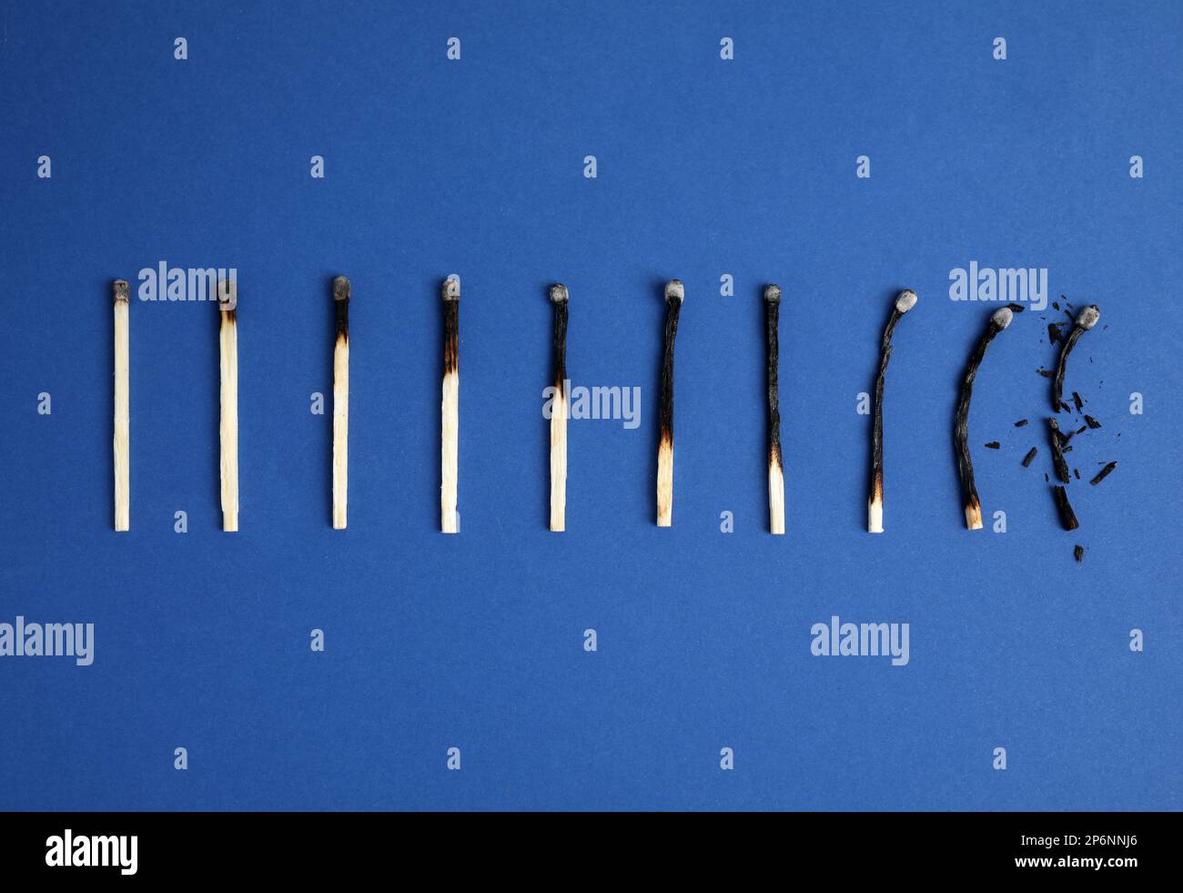 Different stages of burnt matches on blue background, flat lay Stock ...