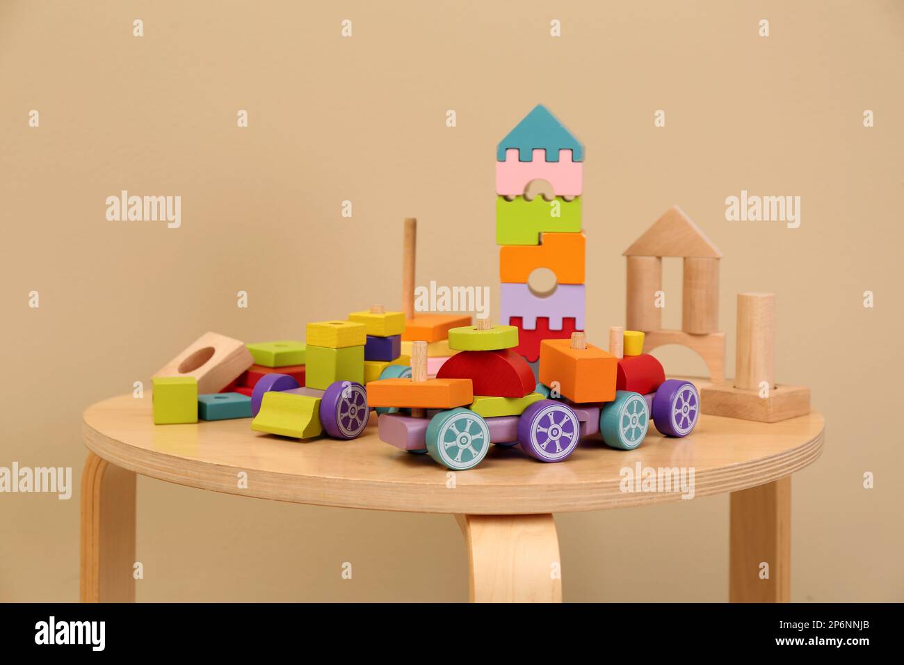 Set of different wooden toys on table against beige background Stock ...