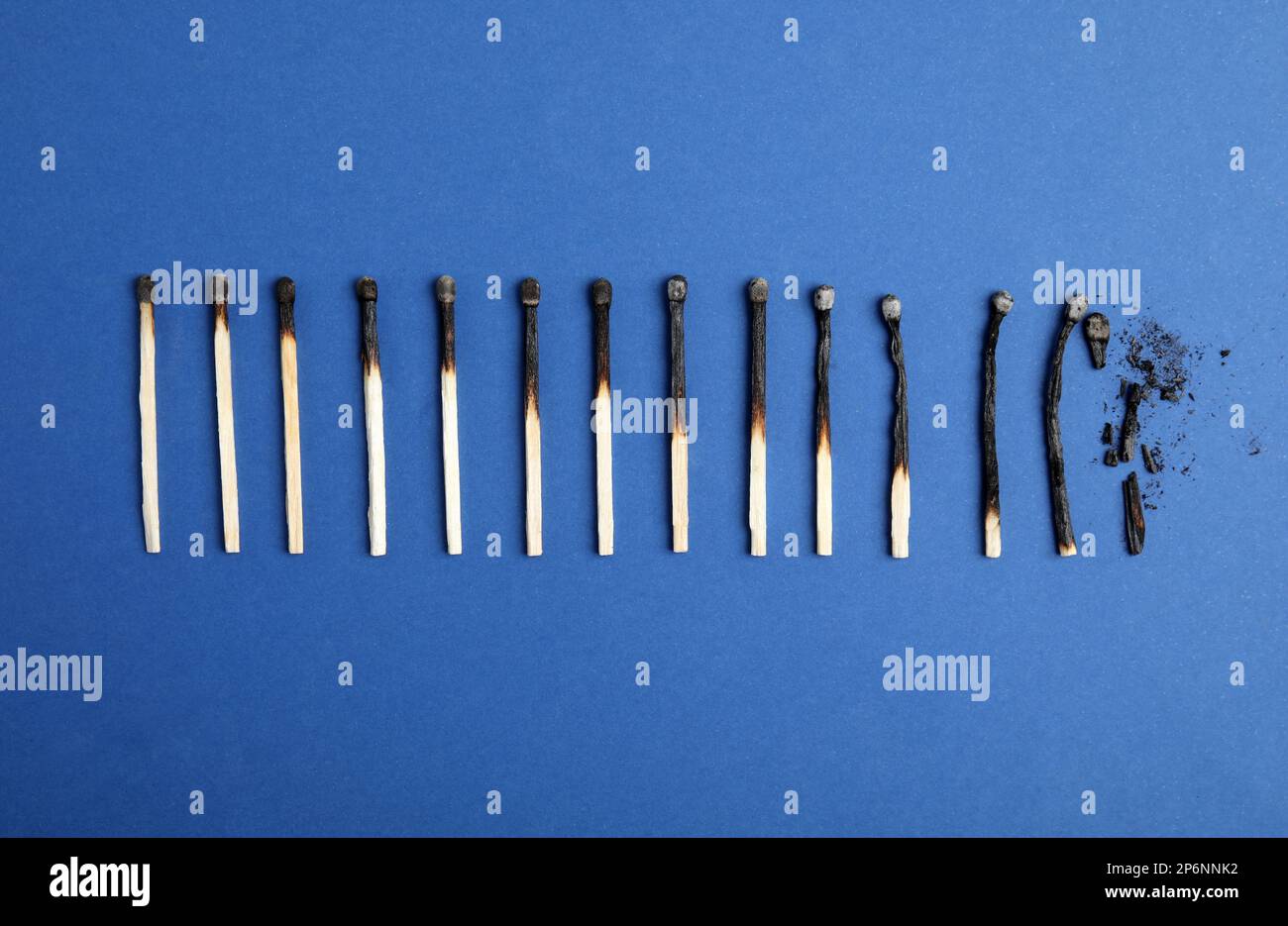 Different stages of burnt matches on blue background, flat lay Stock ...