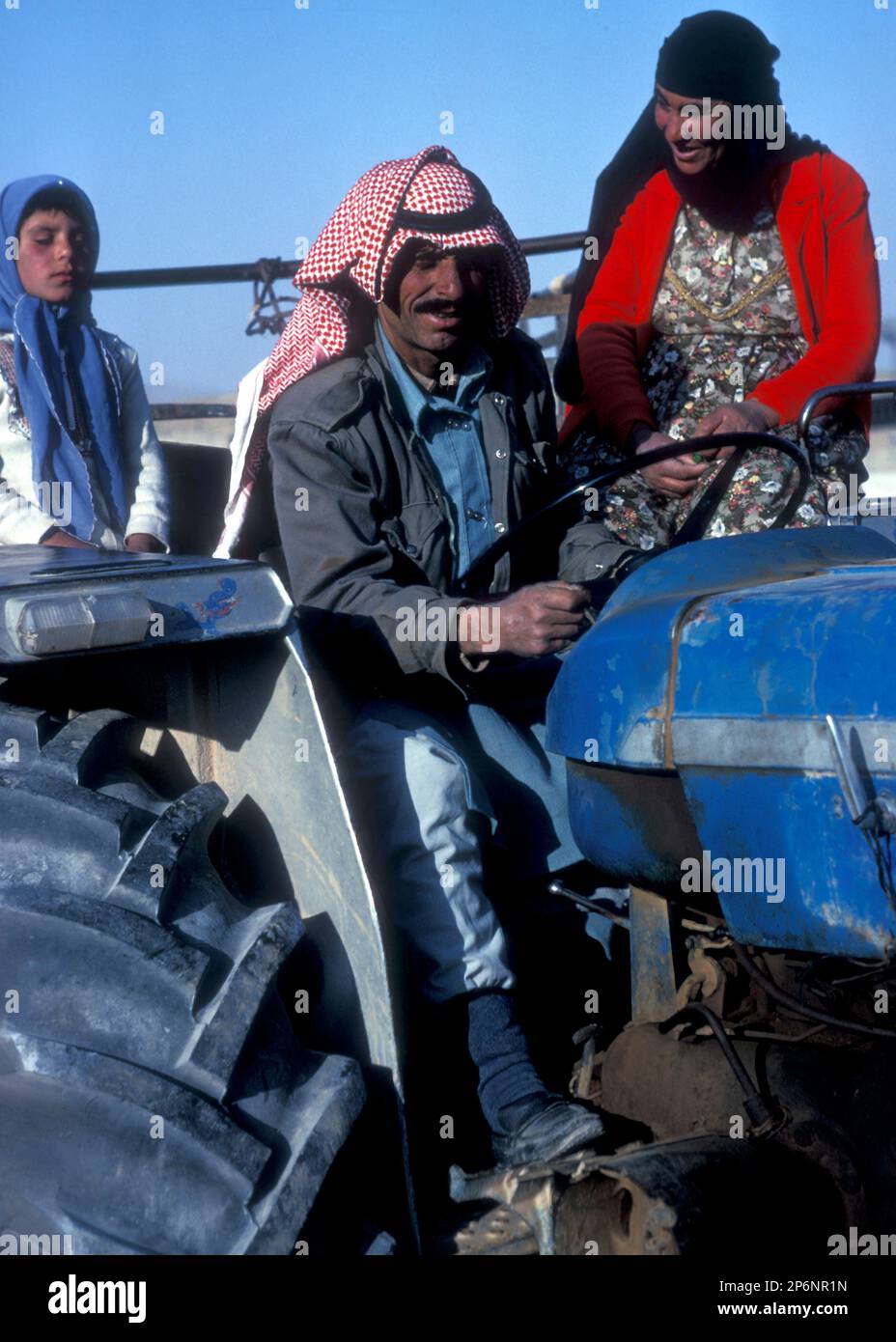 Syrian farmer with wife and child on a tractor, Syria 1984 Stock Photo ...