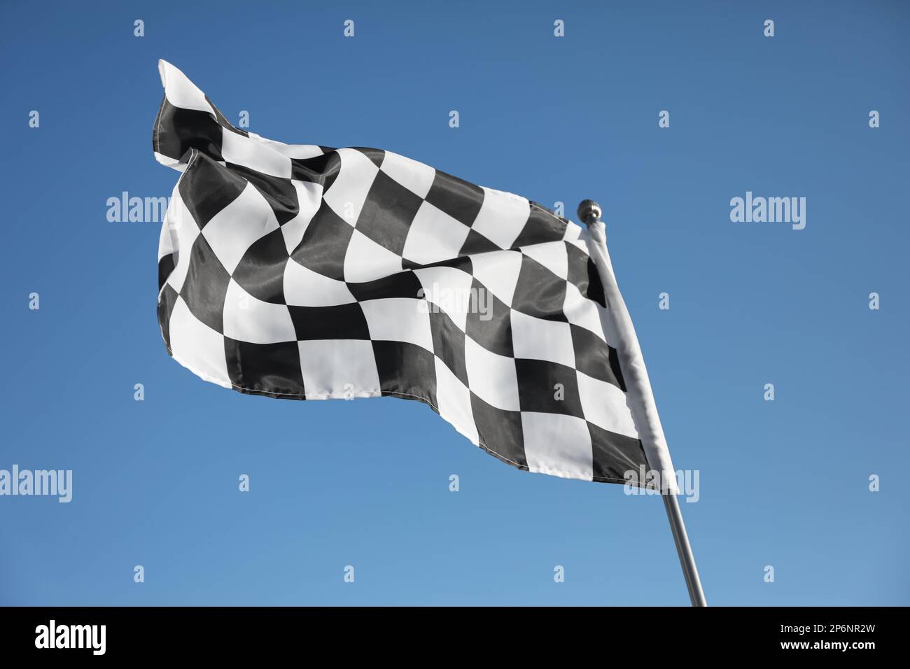 Checkered finish flag on light blue background Stock Photo - Alamy