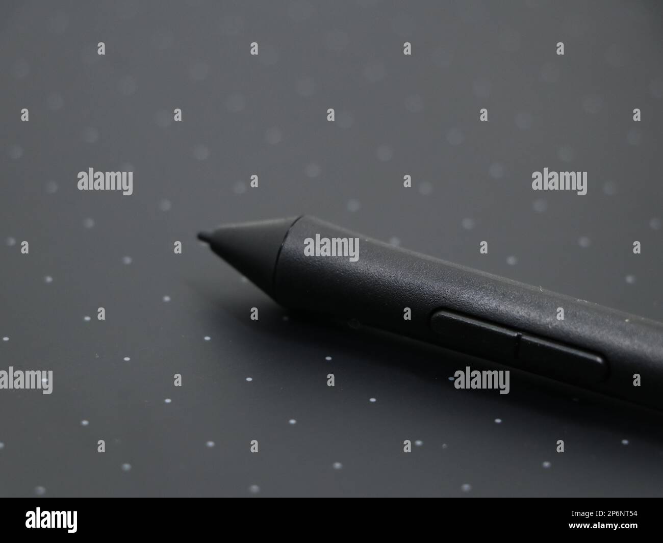 closeup of a black digital stylus touch pen tool on a sketching tablet ...