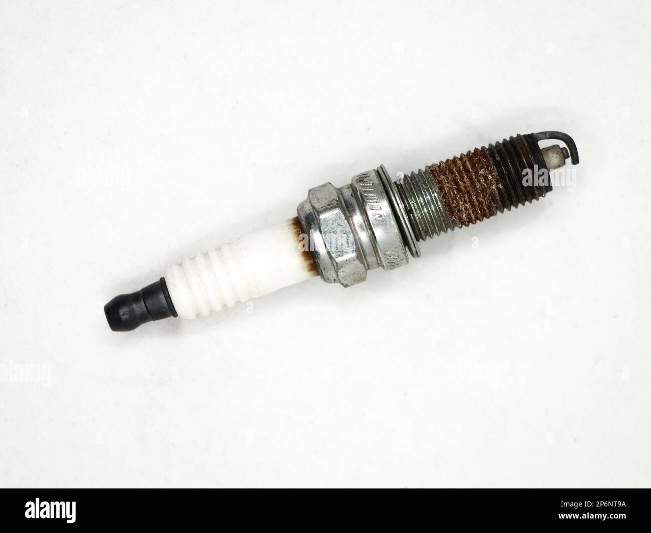 closeup of an old used rusty copper spark plug which is a component in ...