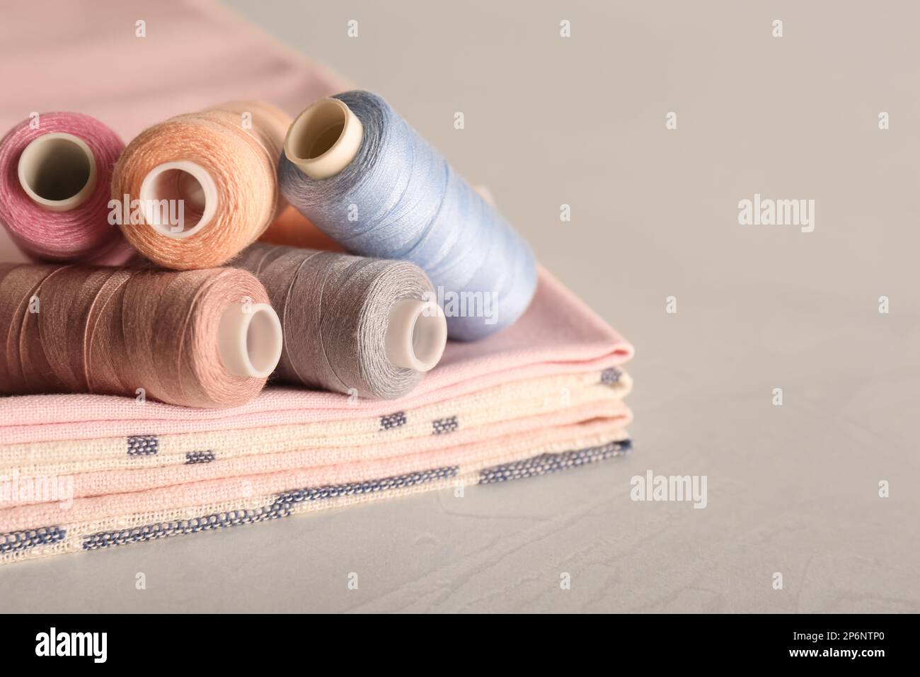 Set of color sewing threads on light grey table, space for text Stock ...