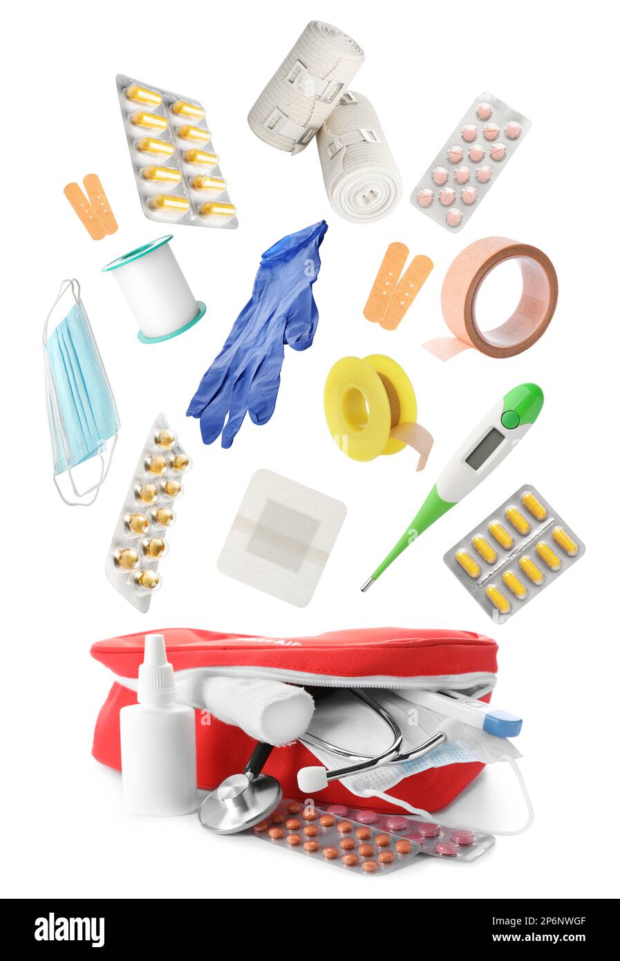 First aid kit. Different medical supplies falling on white background ...