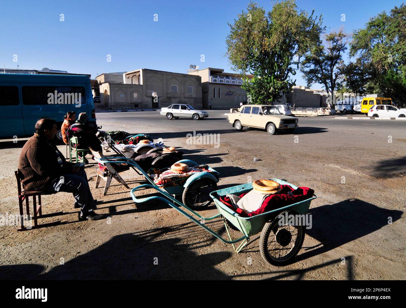 Obi-Non vendors selling the bread from a small traditional pull-carts ...