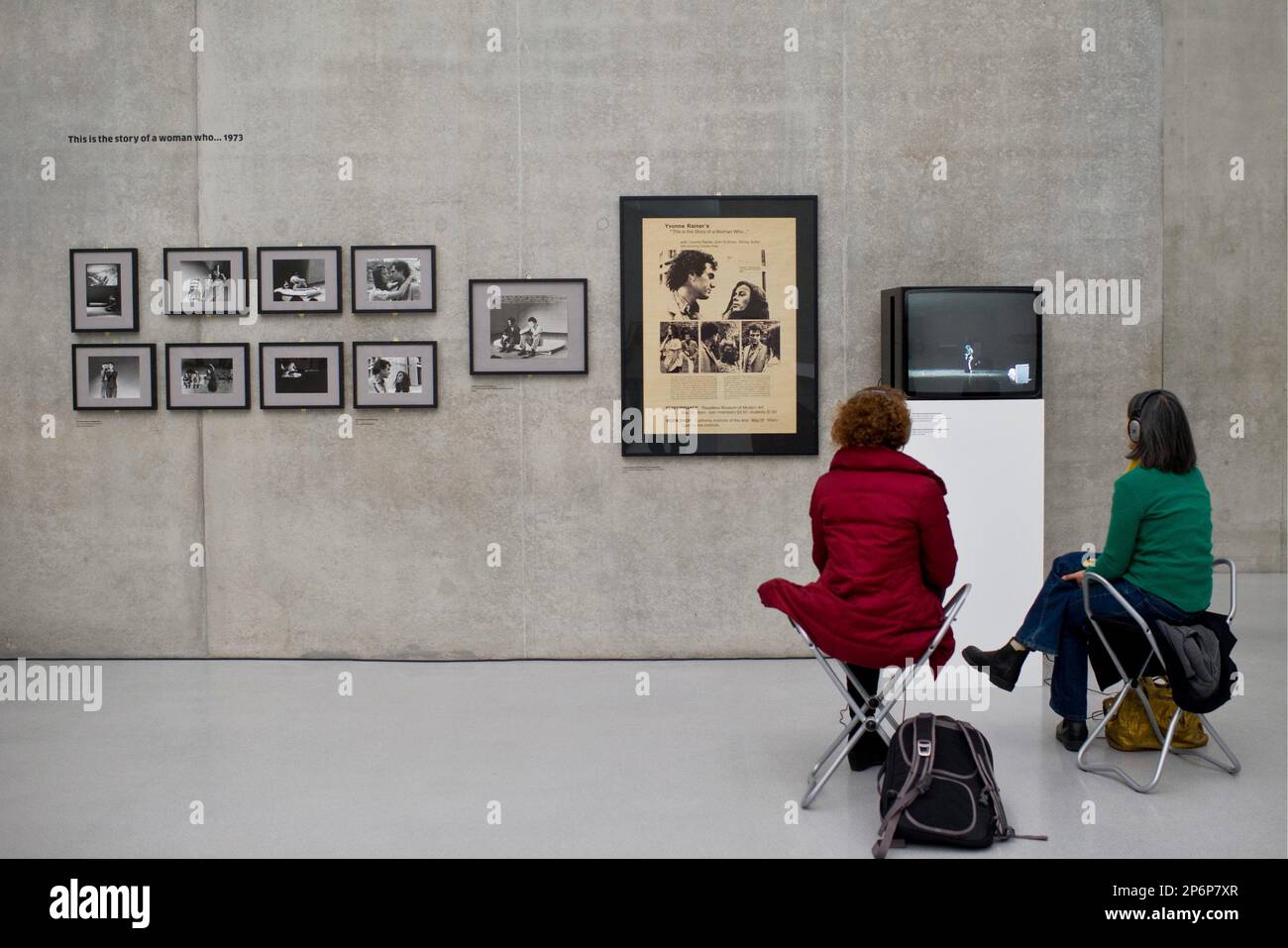 Visitors watch an installation by American artist Yvonne Rainer at the ...