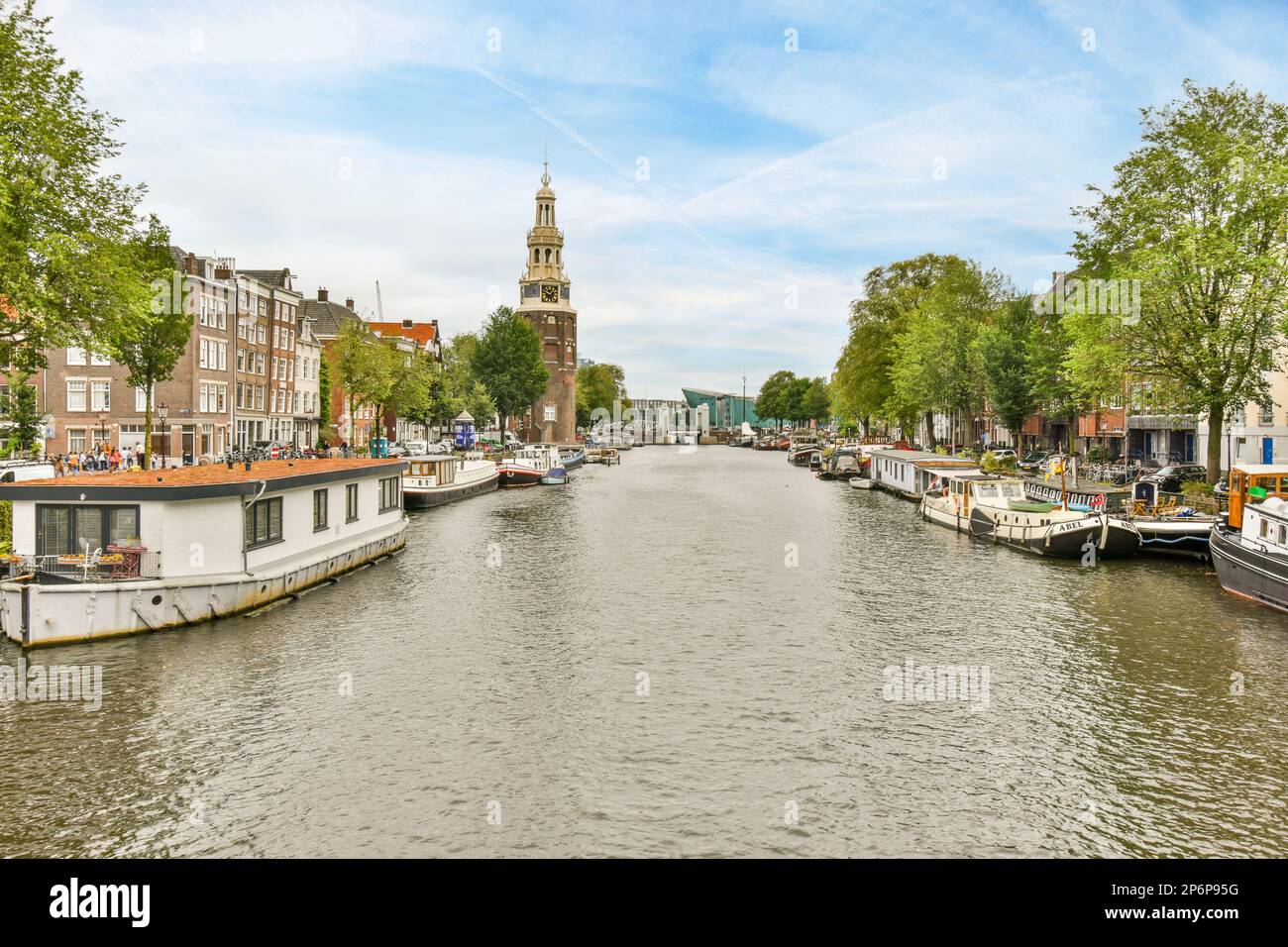 some boats in the water with buildings on either sides and a clock ...
