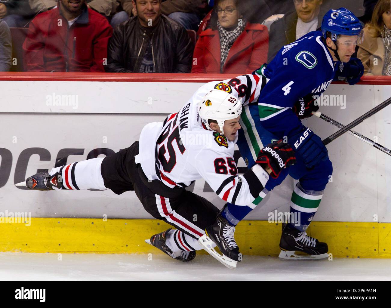 Chicago Blackhawks' Andrew Shaw, left, crashes into Vancouver Canucks ...