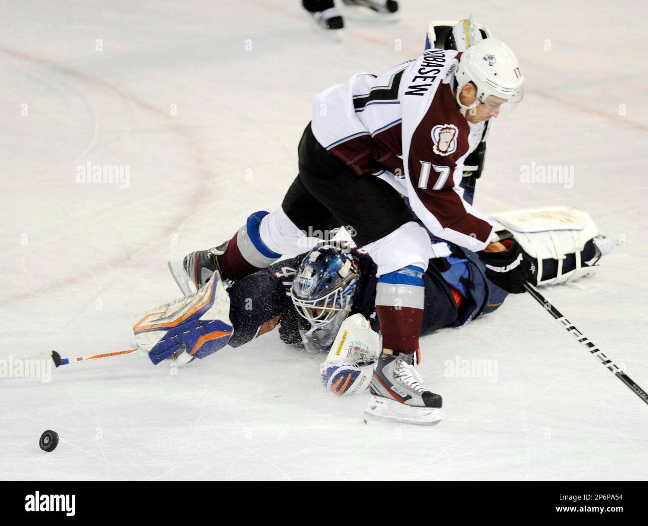 Edmonton Oilers' goalie Devan Dubnyk, bottom, intercepts the puck from ...