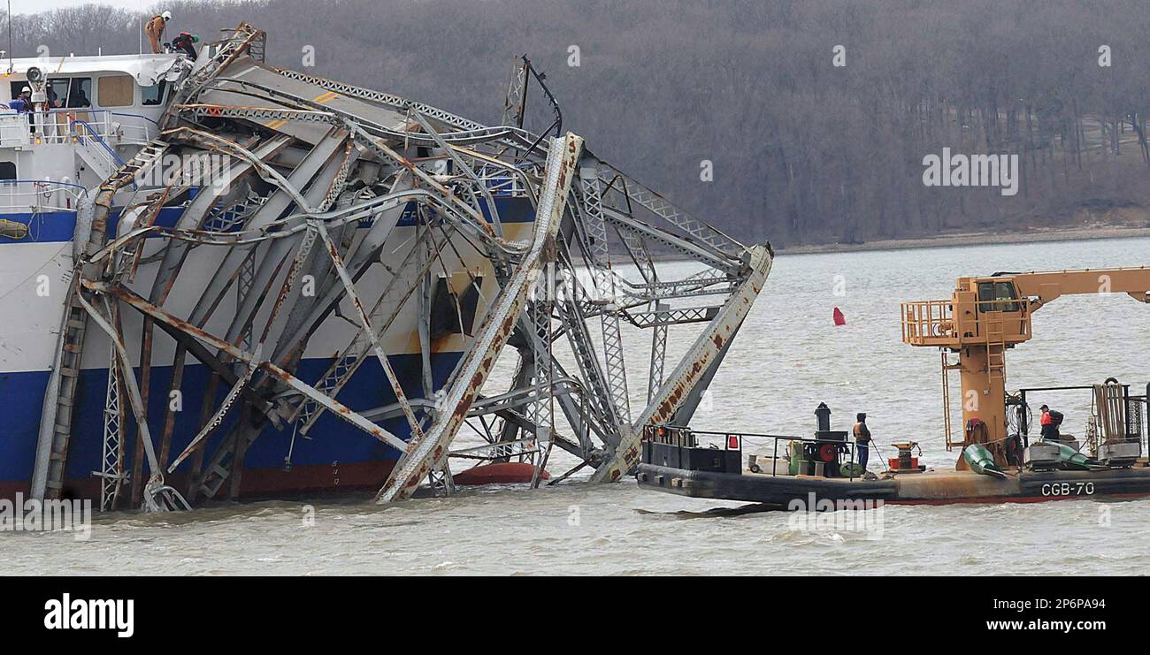 Crewmen wearing hard hats stand atop the cargo ship Delta Mariner ...