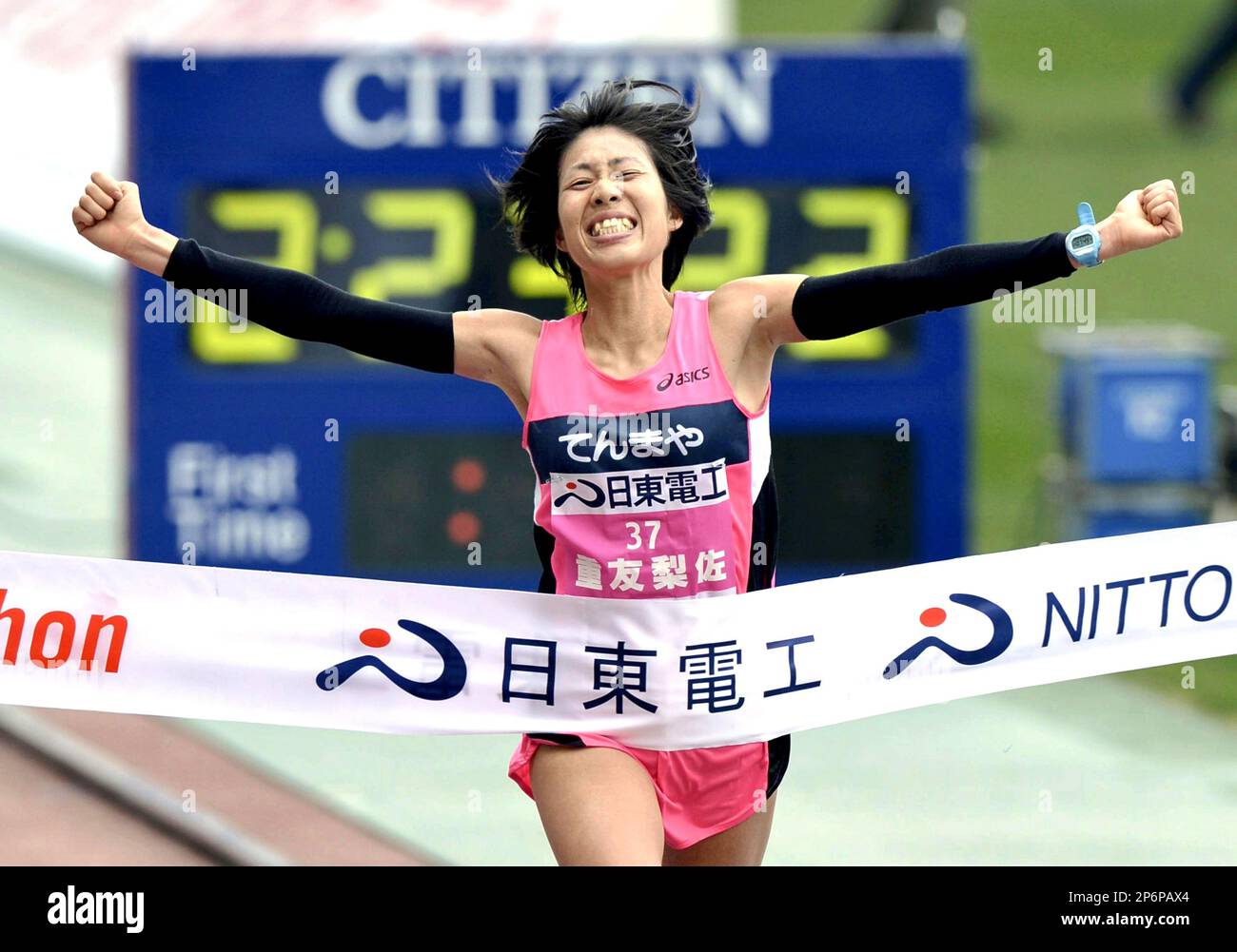 Risa Shigetomo of Japan crosses the finish line to win Osaka Women's Marathona at Nagai Stadium ...