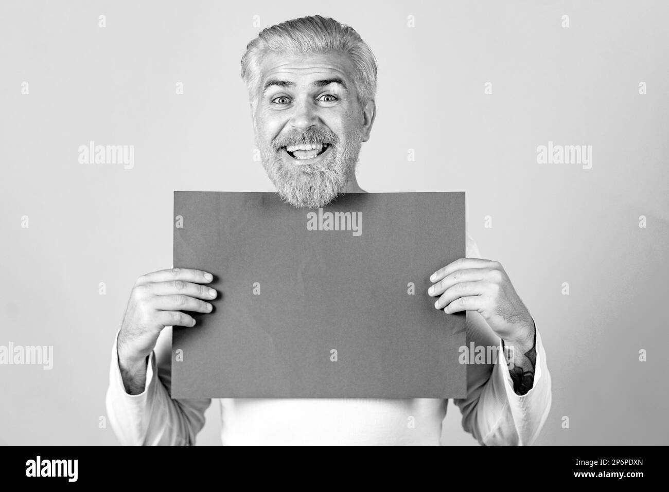 Portrait of funny man showing blank signboard with copyspace area for ...