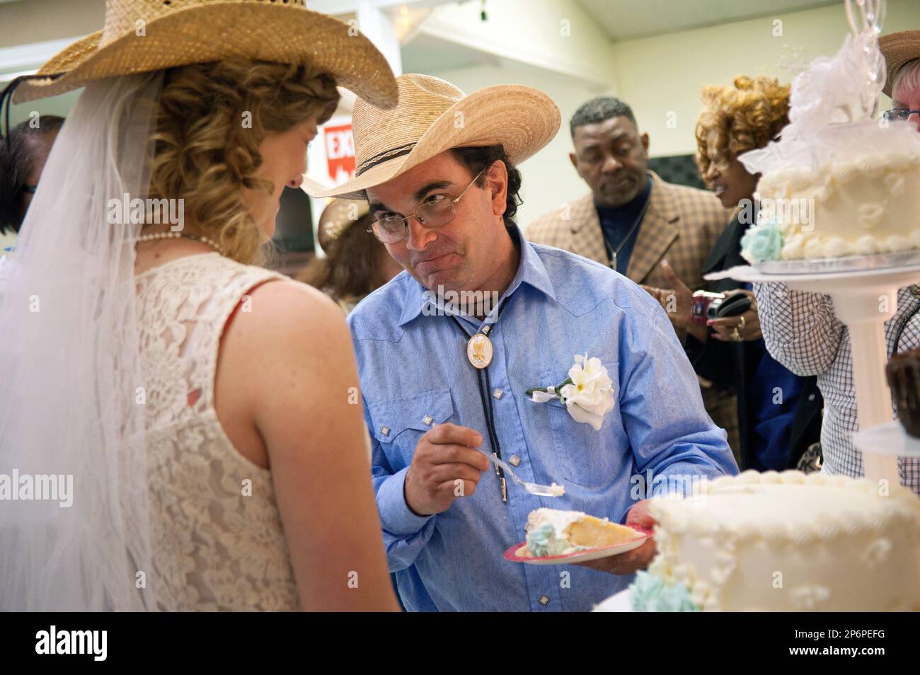 Robert Everett, 47, feeds his new wife Amber Roach, 24, a piece of ...