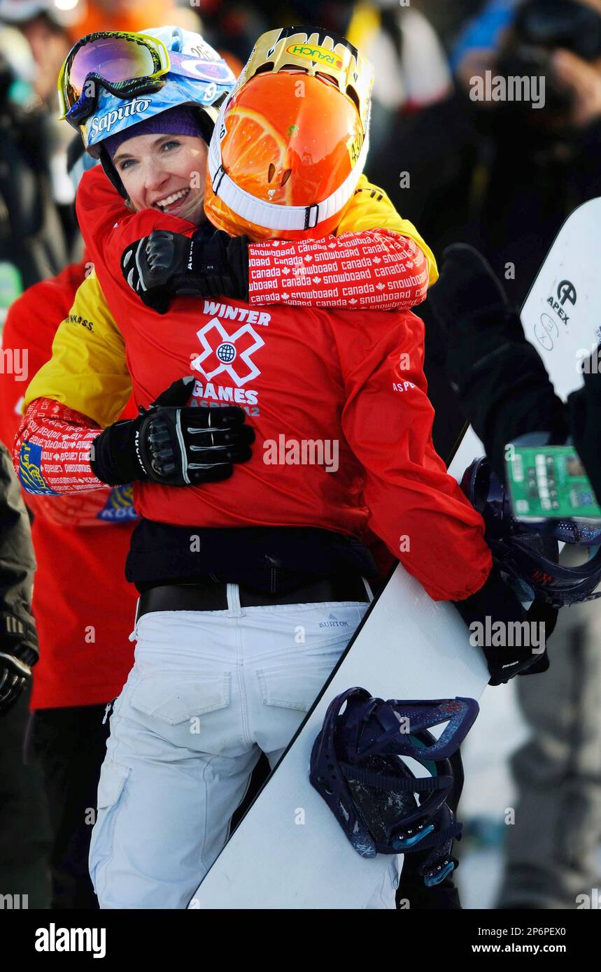 Dominique Maltais, rear, hugs Susi Moll after winning the gold in the ...