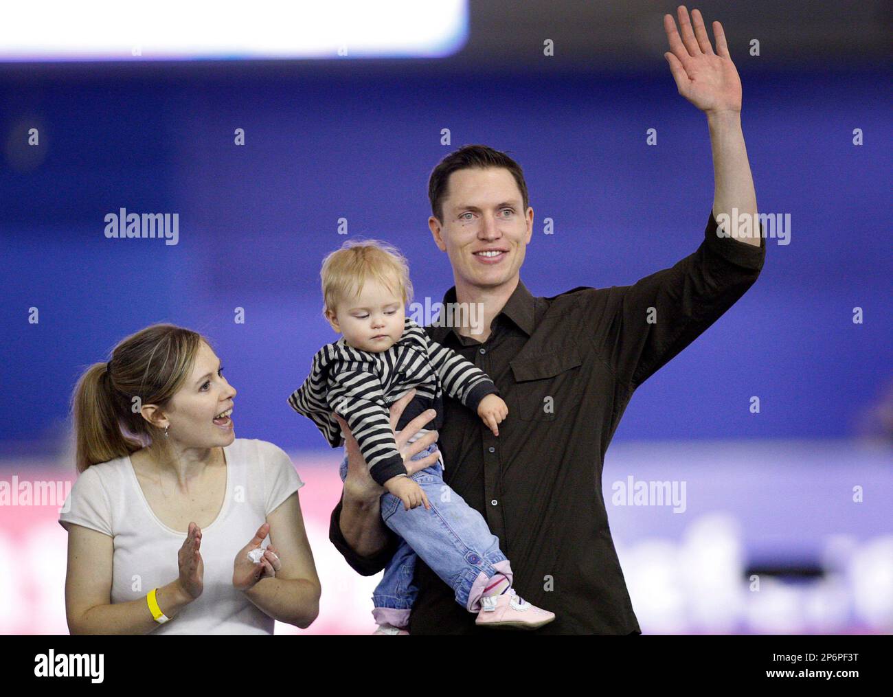 Jeremy Wotherspoon, right, waves to the crowd while holding his ...