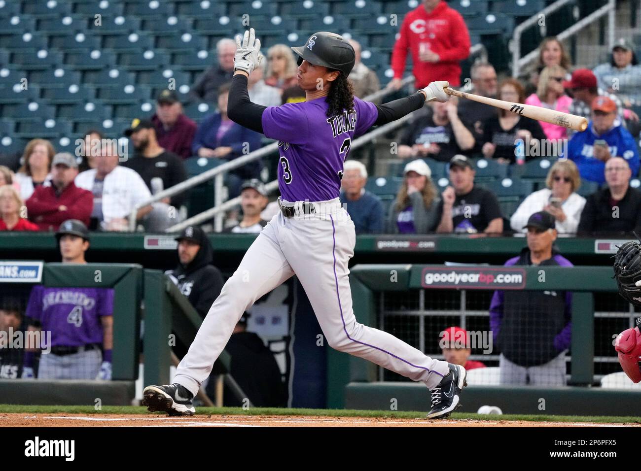 Colorado Rockies' Cole Tucker follows through on his swing against the ...