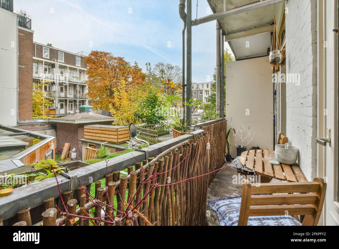 an outside area with furniture and plants on the balcony, taken from ...
