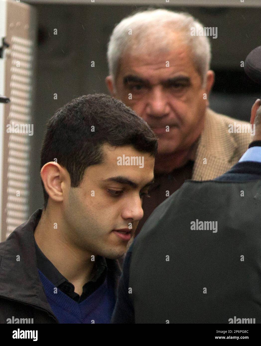 Hamed Shafia, front, and his father Mohammad Shafia are escorted into ...