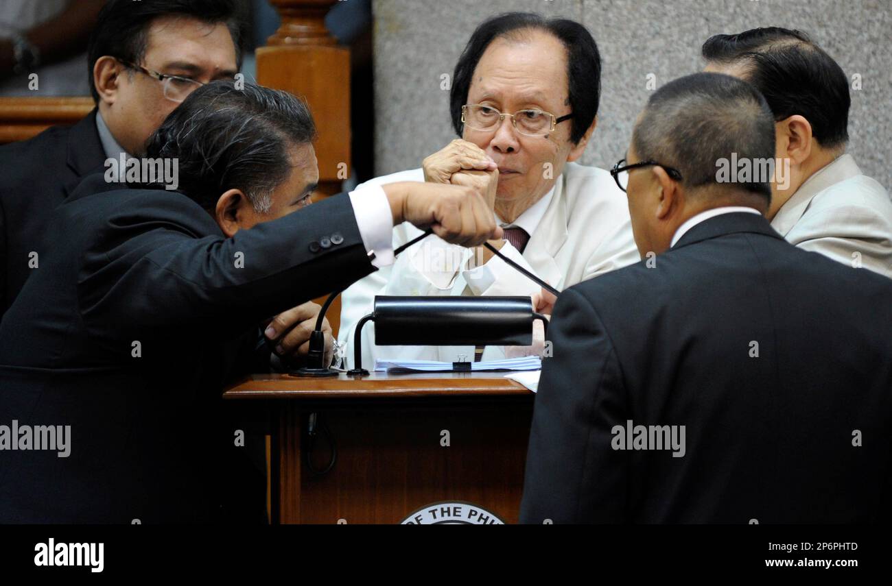 Members of the defense panel huddle around during the recess of the ...
