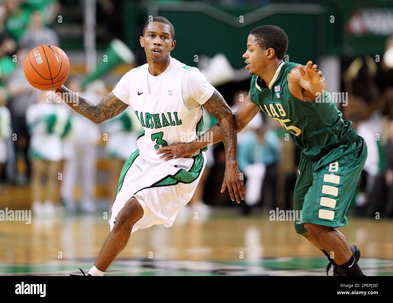 Marshall's Damier Pitts, left, drives against UAB's Quincy Taylor ...