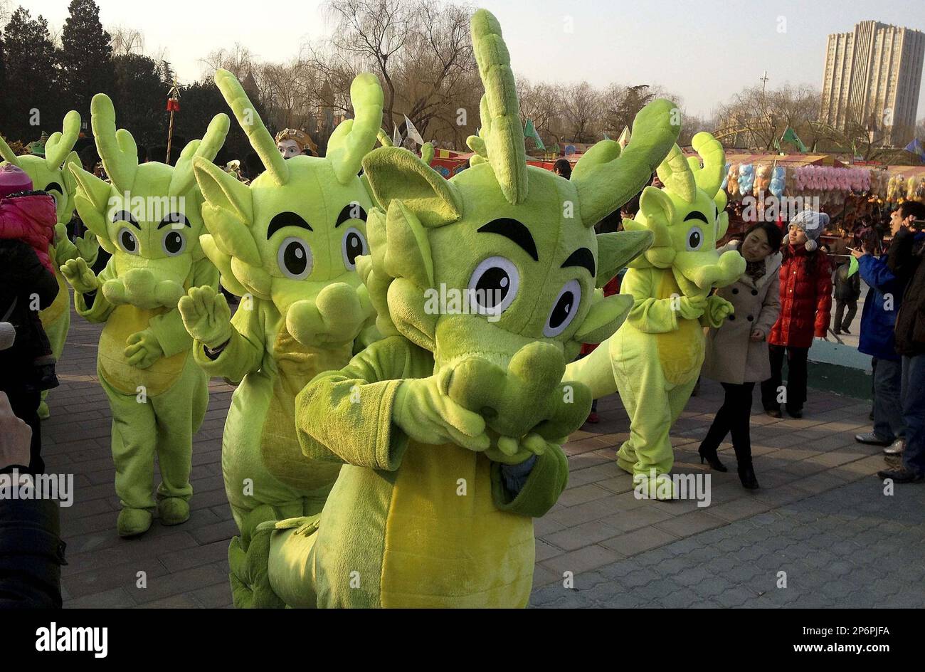 People dressed as dragon attend the foreign temple fair at Shijing ...