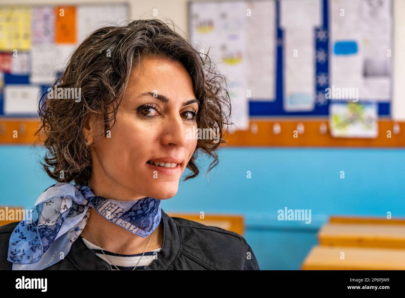 Caucasian female portrait of young smiling teacher in classroom ...